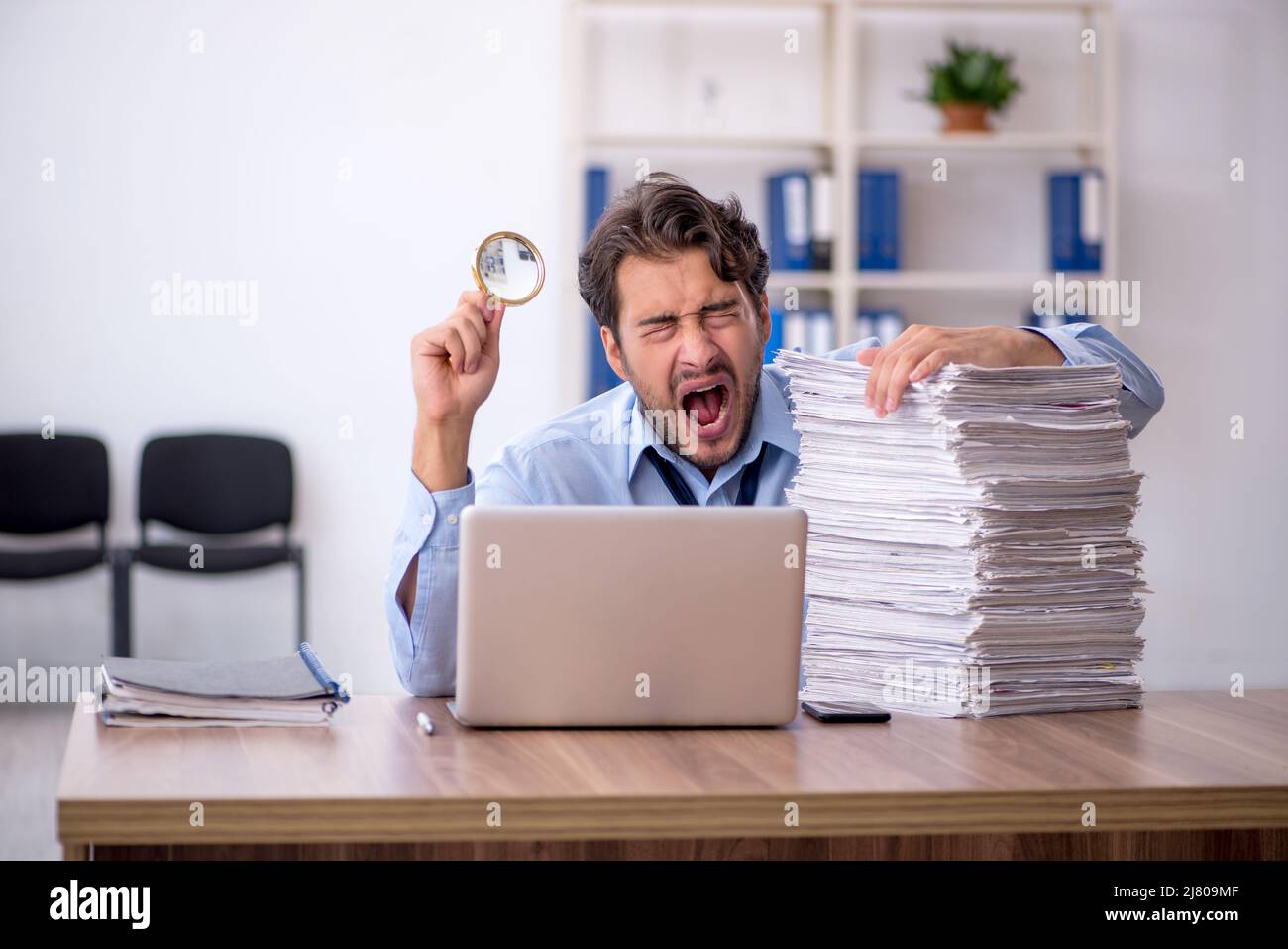Young businessman employee and too much work in the office Stock Photo ...