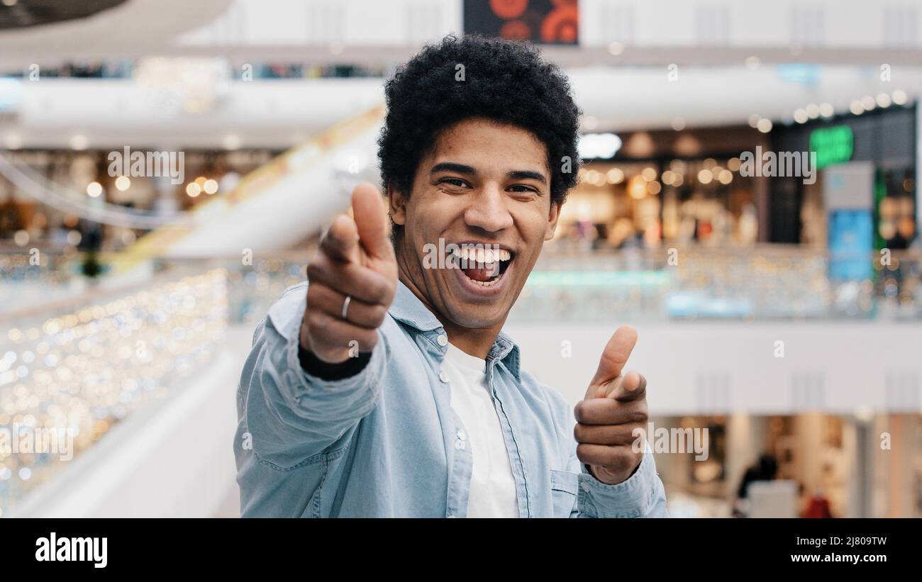 Hey you gesture indoor portrait african man pointing index fingers to ...