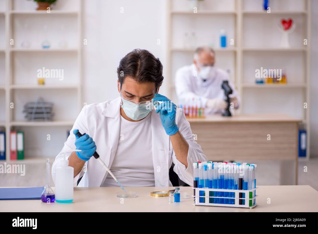 Two chemist working at the lab Stock Photo - Alamy