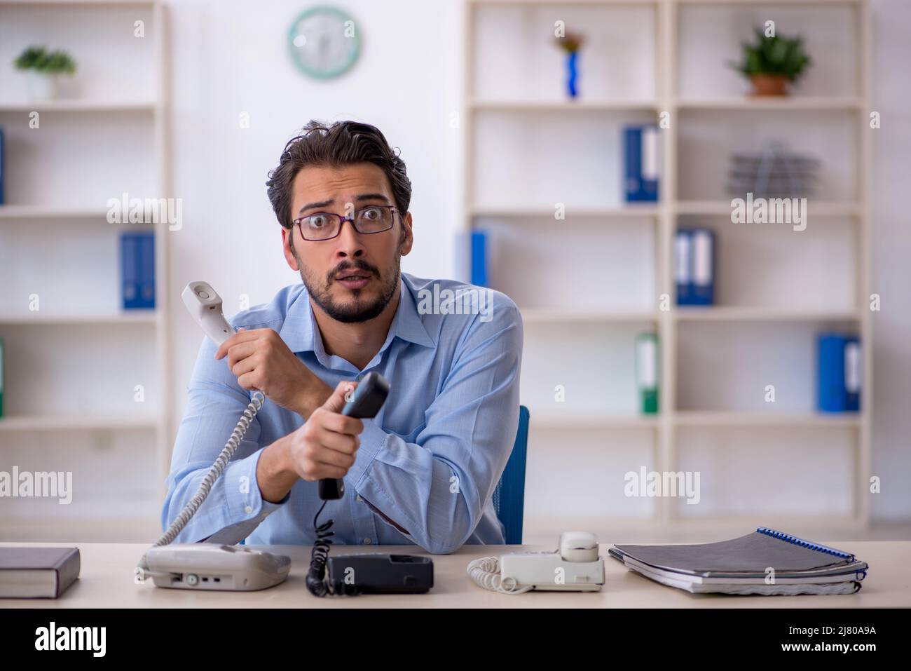 Overworked office receptionist hi-res stock photography and images - Alamy