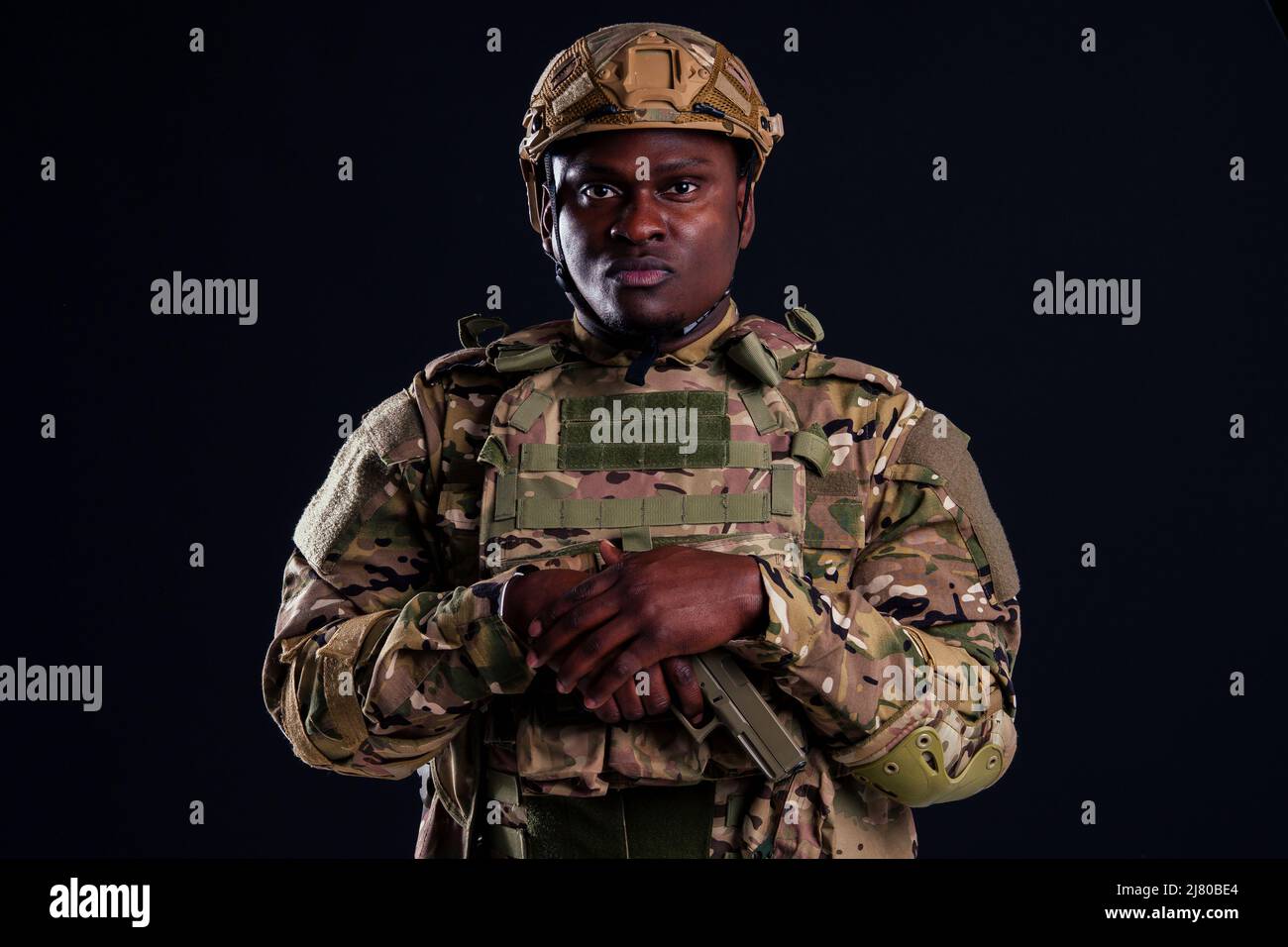 African american soldier with folded arms standing in white studio ...