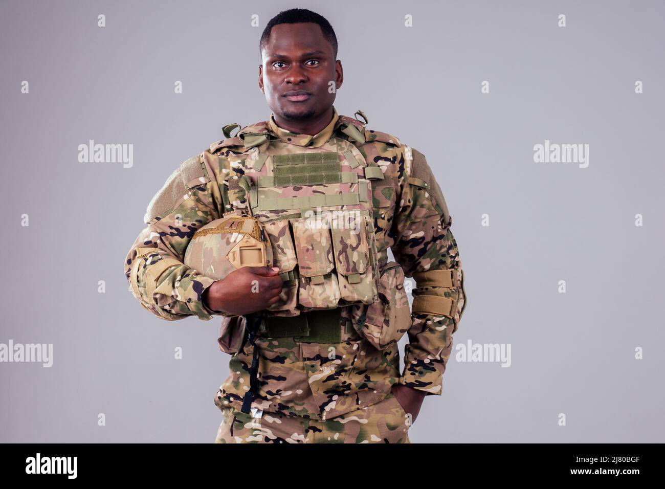 African american soldier with folded arms standing in white studio ...