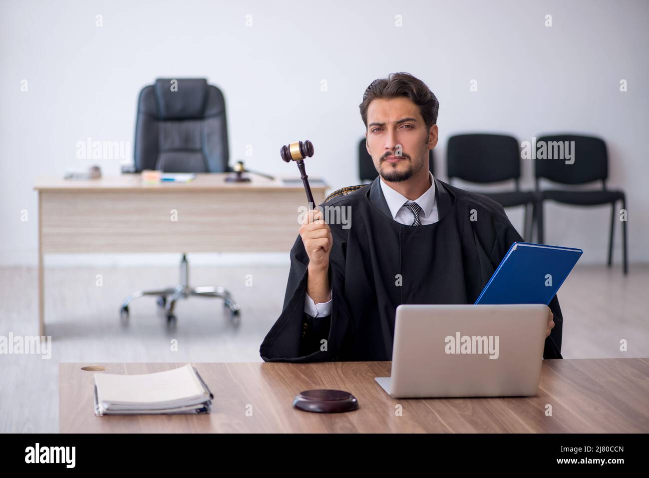 Young judge working in the courthouse Stock Photo - Alamy