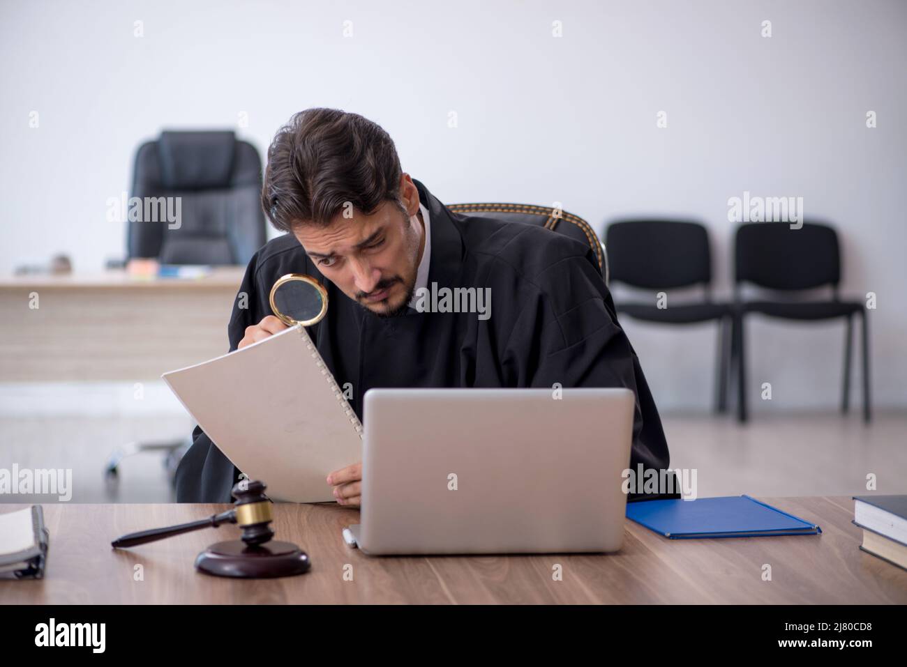 Young judge working in the courthouse Stock Photo - Alamy