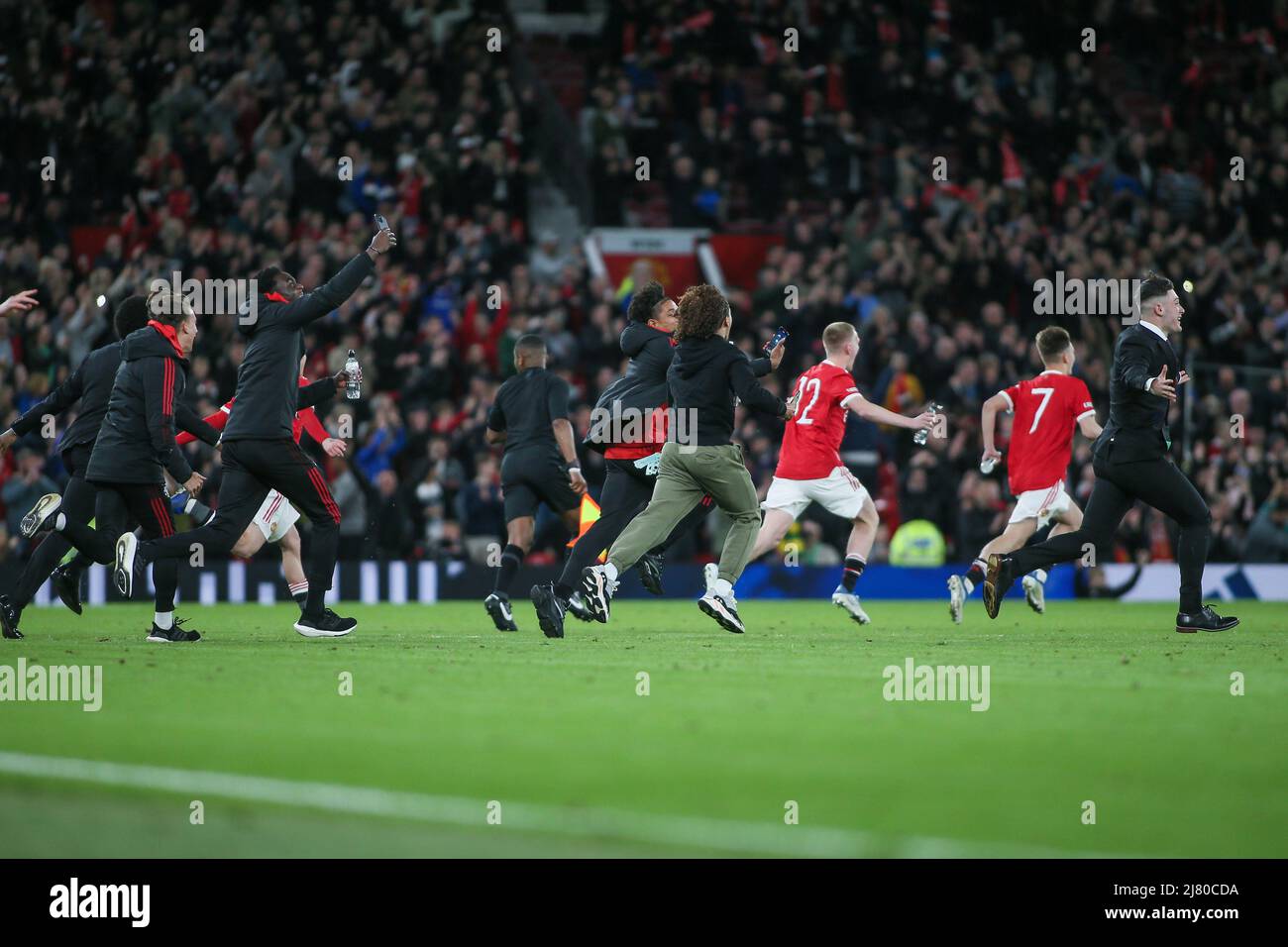 The Manchester United bench head onto the pitch to start the ...