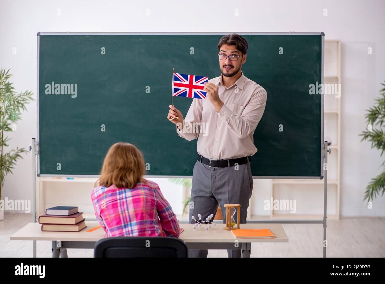 Young english language teacher and redhead girl in the classroom Stock ...