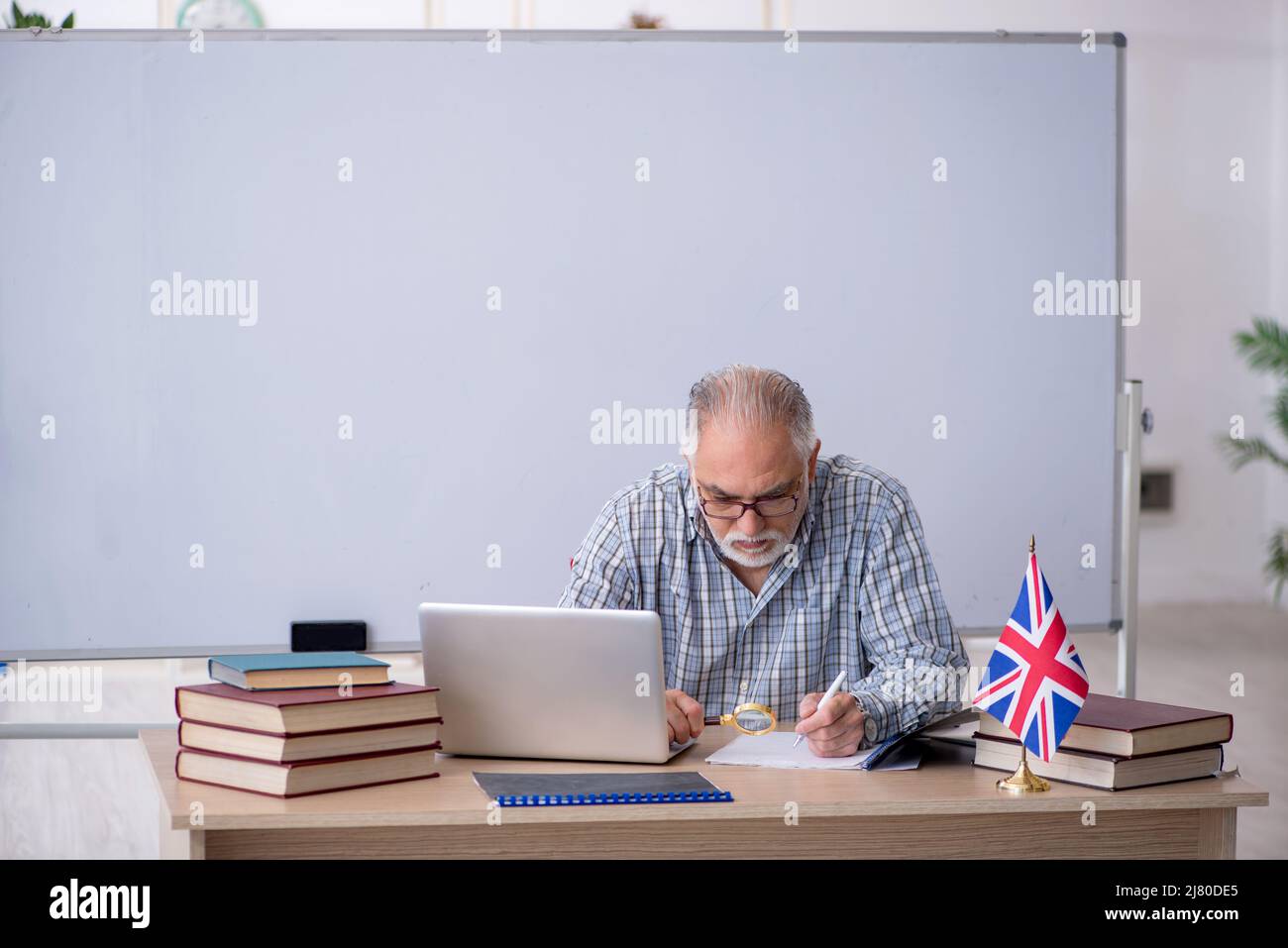 Aged english language teacher in the classroom Stock Photo - Alamy