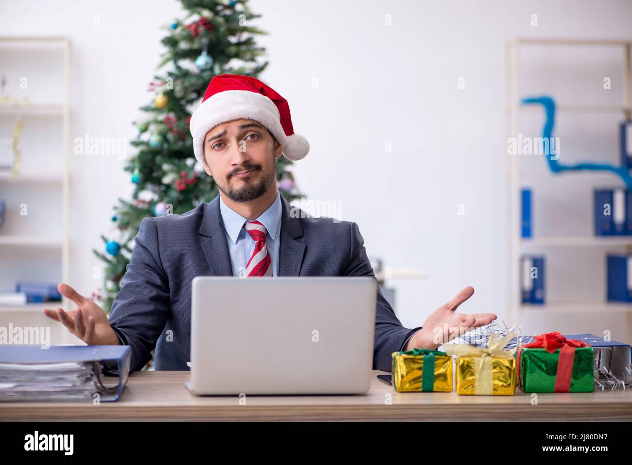 Young employee celebrating Christmas in the office Stock Photo - Alamy