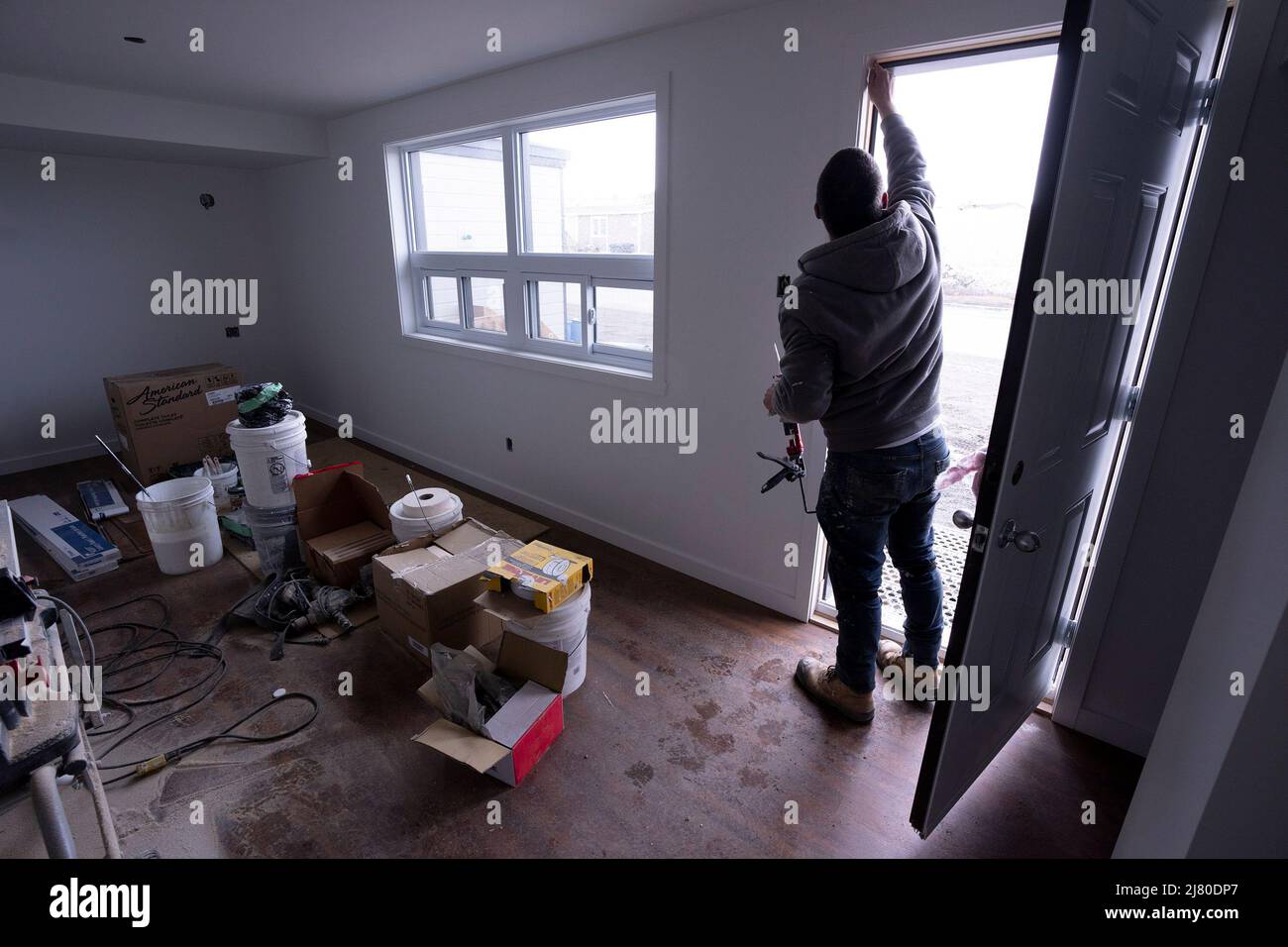 Pascal Landry works on a door frame at a new construction Wednesday ...