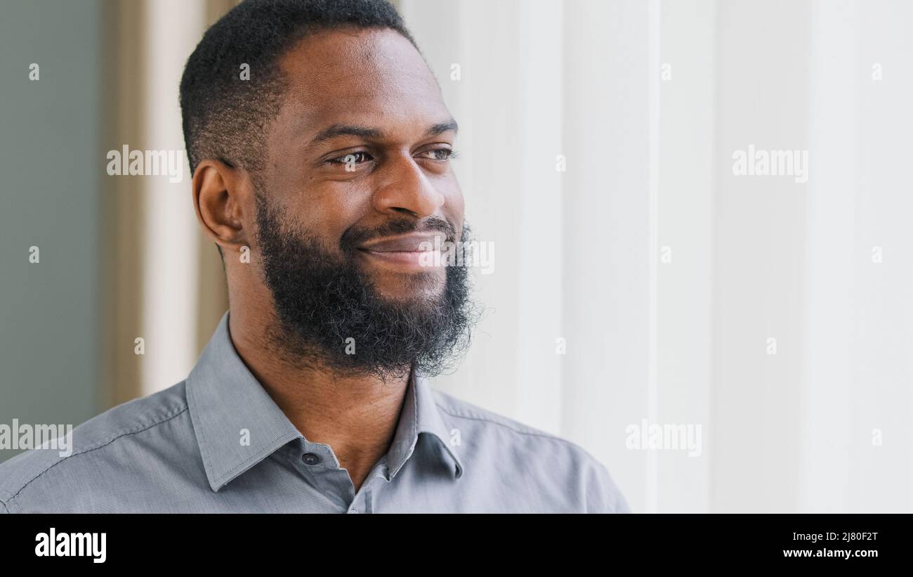 Smiling happy young African American guy, company employee holding ...