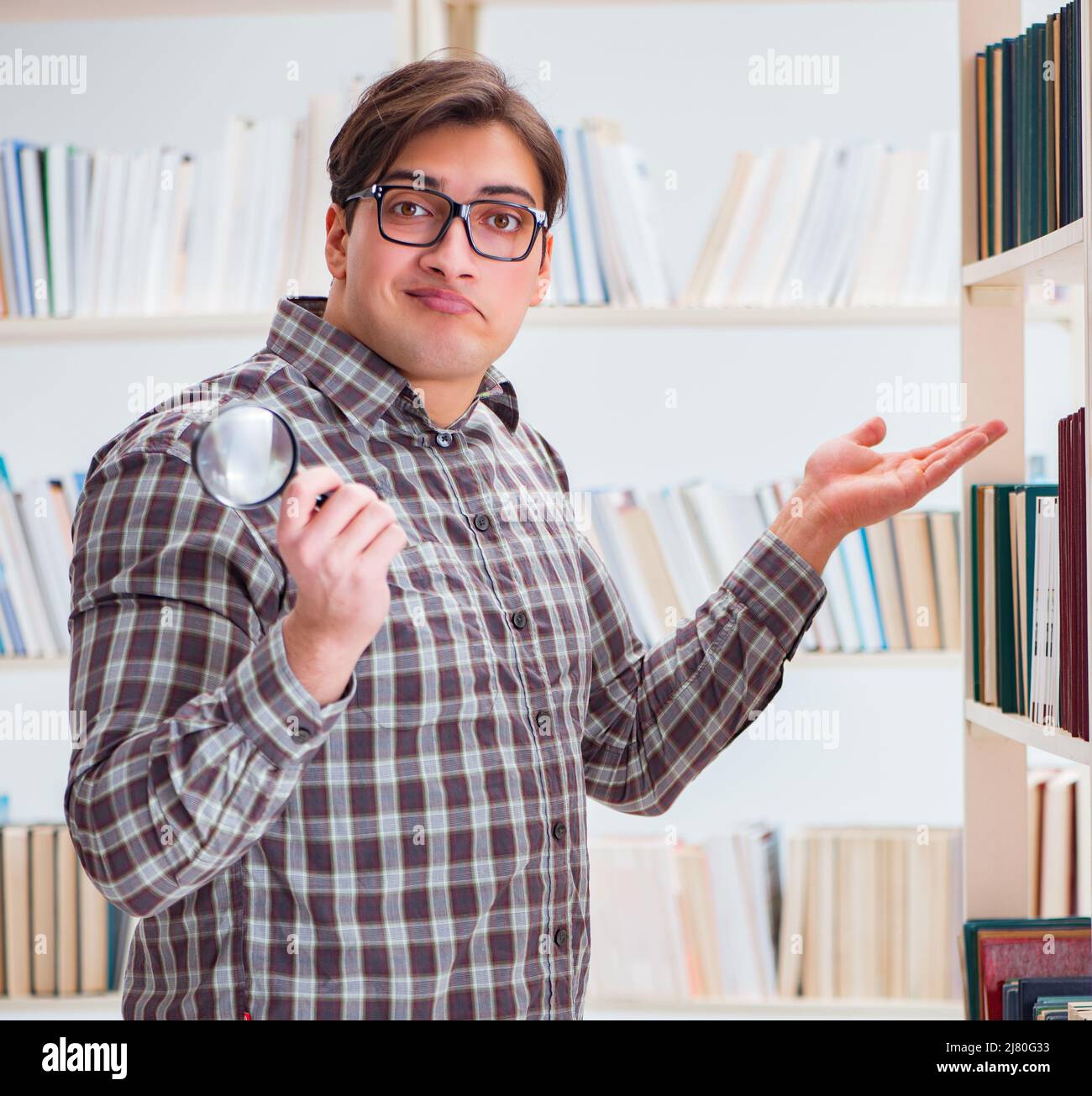 The young student looking for books in college library Stock Photo - Alamy