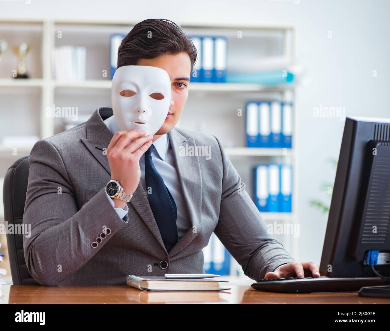 The businessman with mask in office hypocrisy concept Stock Photo - Alamy