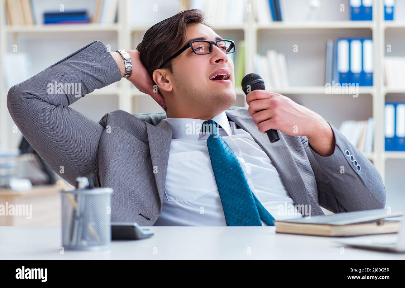 Cheerful businessman singing karaoke hi-res stock photography and ...