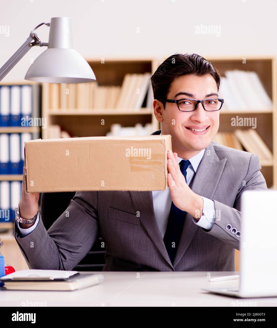 Businessman opening package in office hi-res stock photography and ...