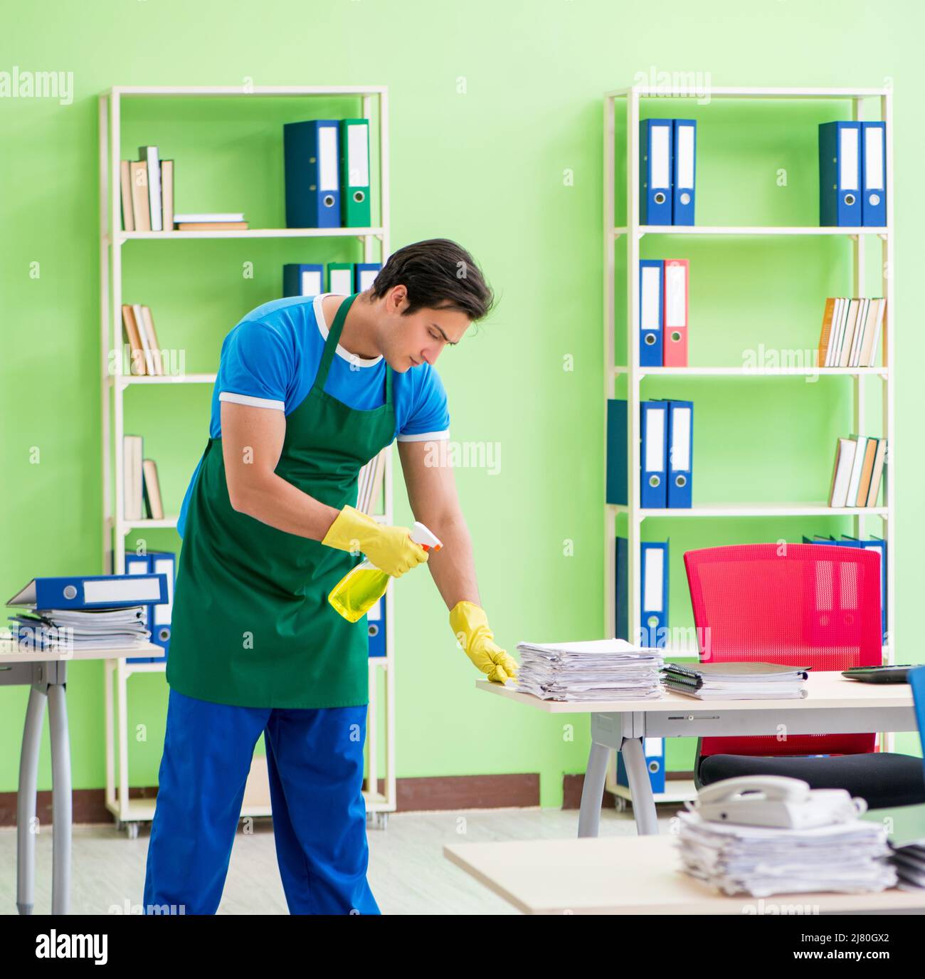 The male handsome professional cleaner working in the office Stock ...