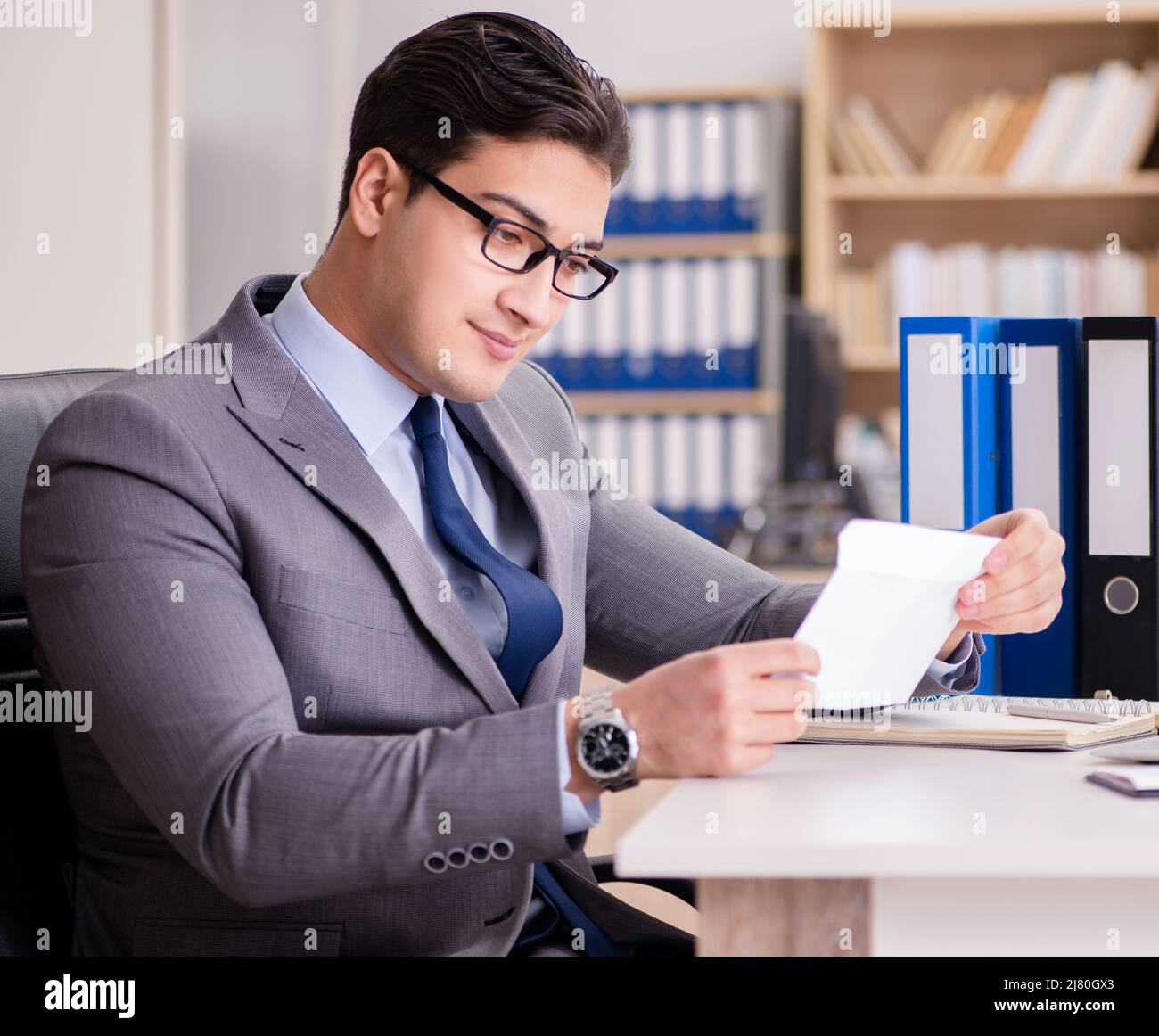 The businessman receiving letter in the office Stock Photo - Alamy