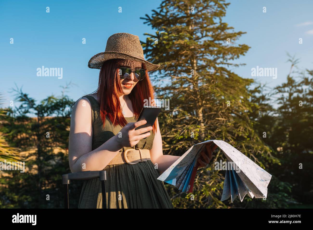 woman looking up the location of the hotel on her mobile phone when ...
