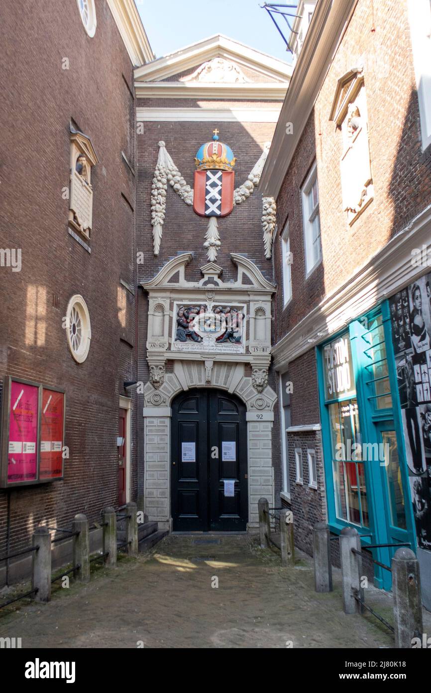 Amsterdam Museum entrance with Amsterdam city crest located in a narrow ...