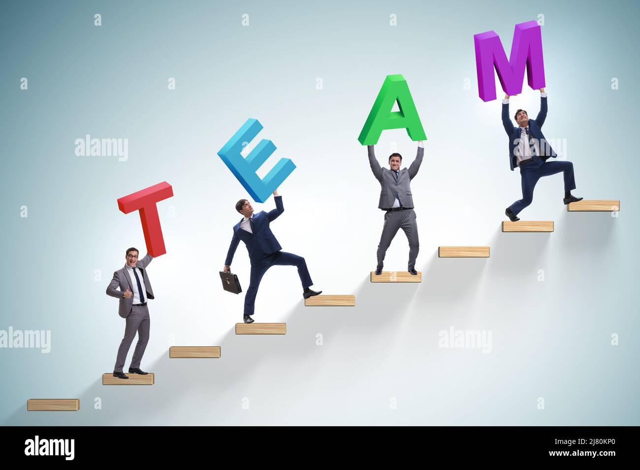 Teamwork concept with the people carrying team letters Stock Photo - Alamy