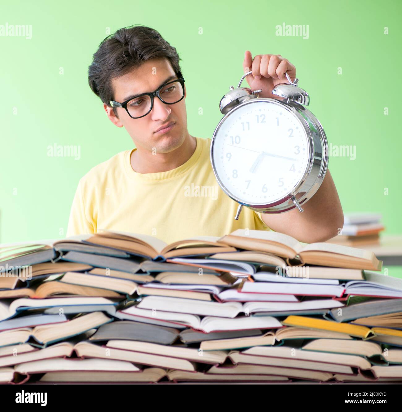 The student with too many books to read before exam Stock Photo - Alamy