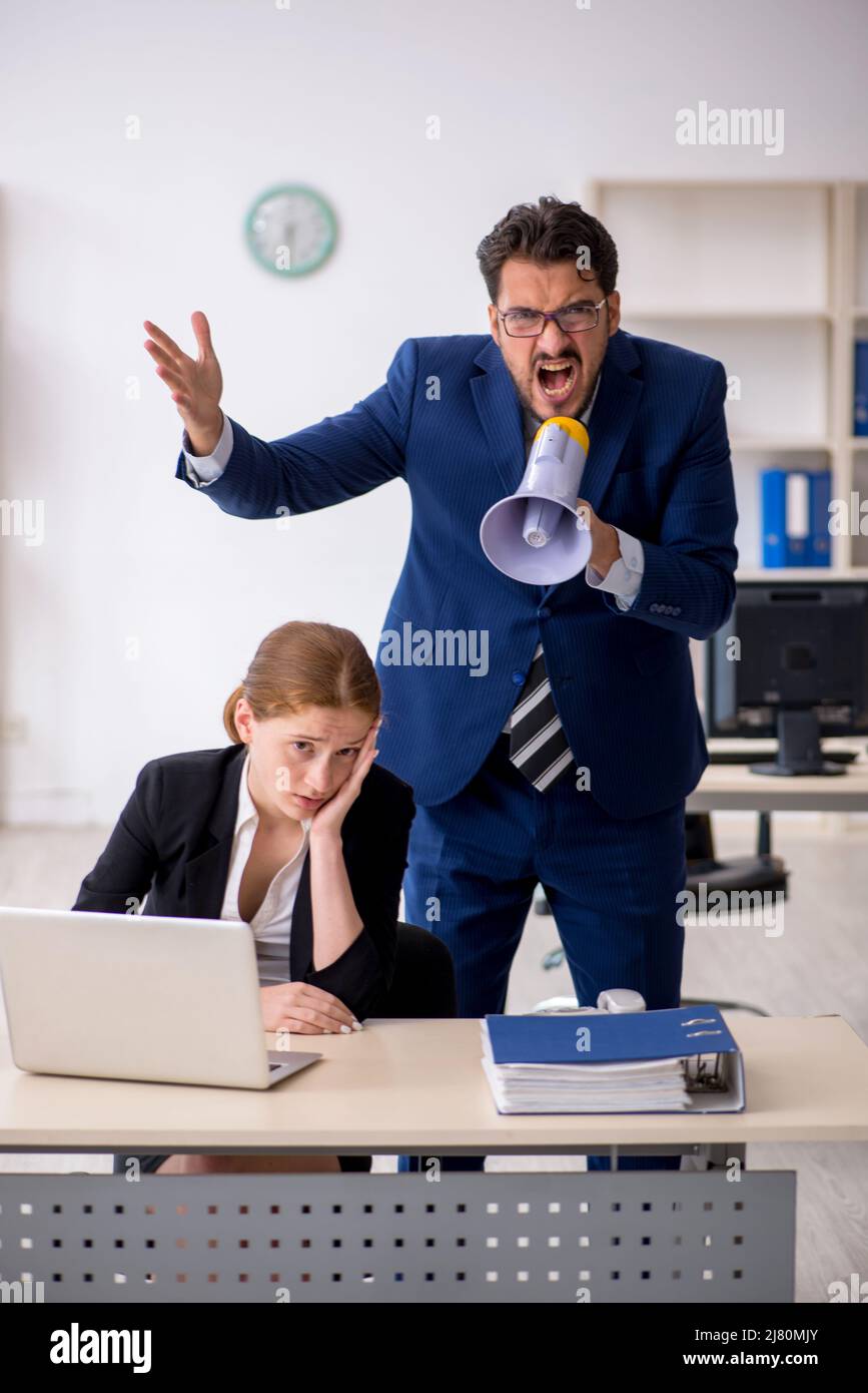 Angry male boss and young female employee at workplace Stock Photo - Alamy
