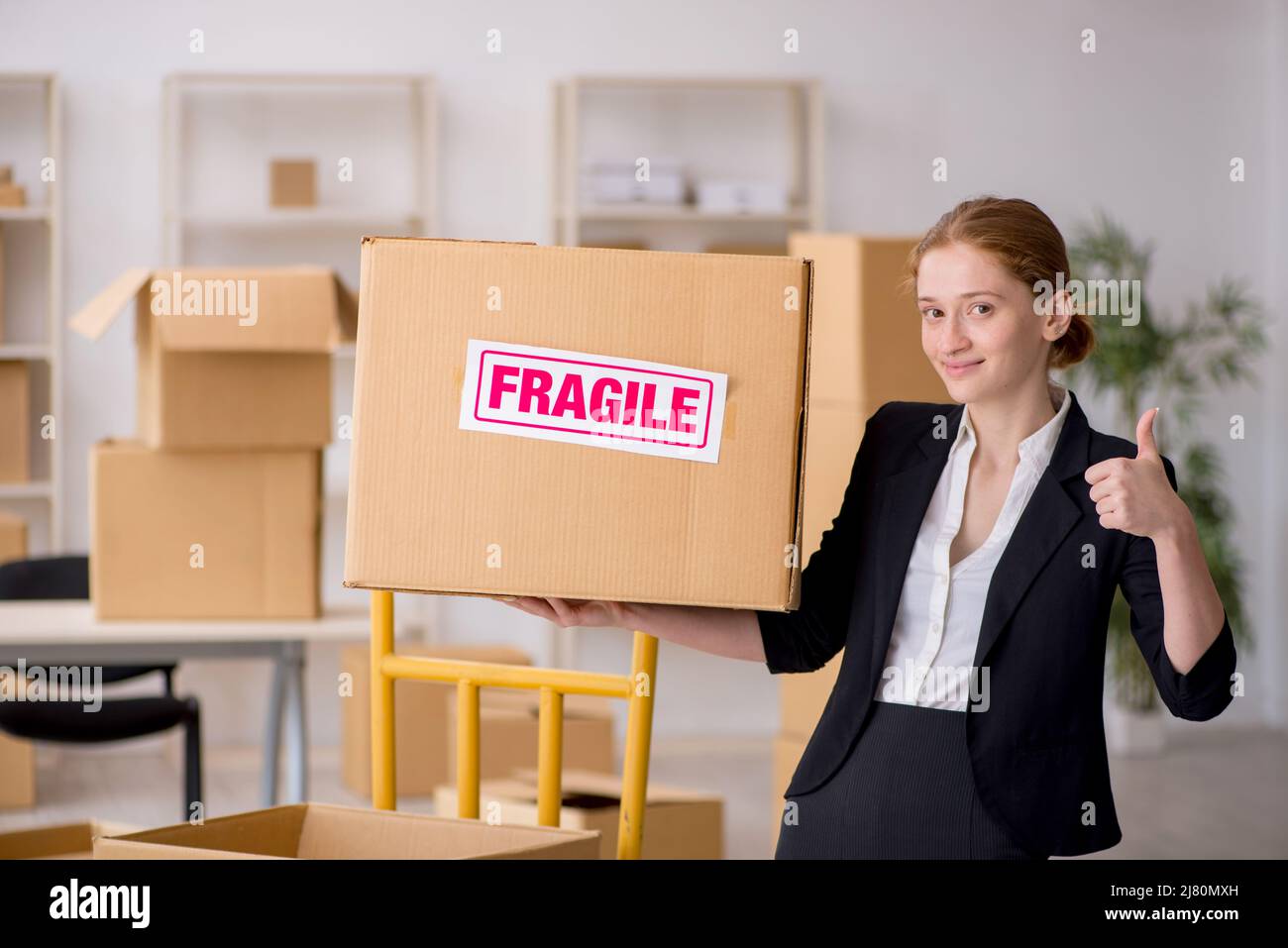 Female professional mover doing home relocation Stock Photo - Alamy