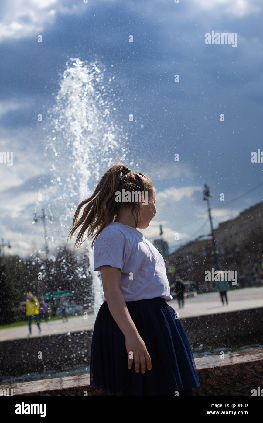 happy little cute girl having fun in splashes a fountain Stock Photo ...