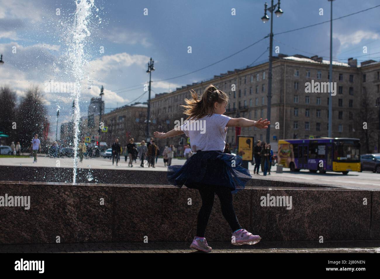 happy little cute girl having fun in splashes a fountain Stock Photo ...