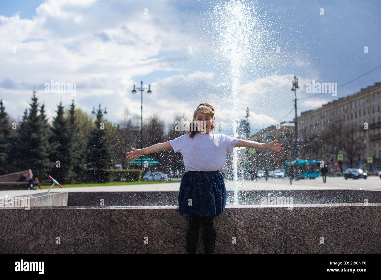 happy little cute girl having fun in splashes a fountain Stock Photo ...