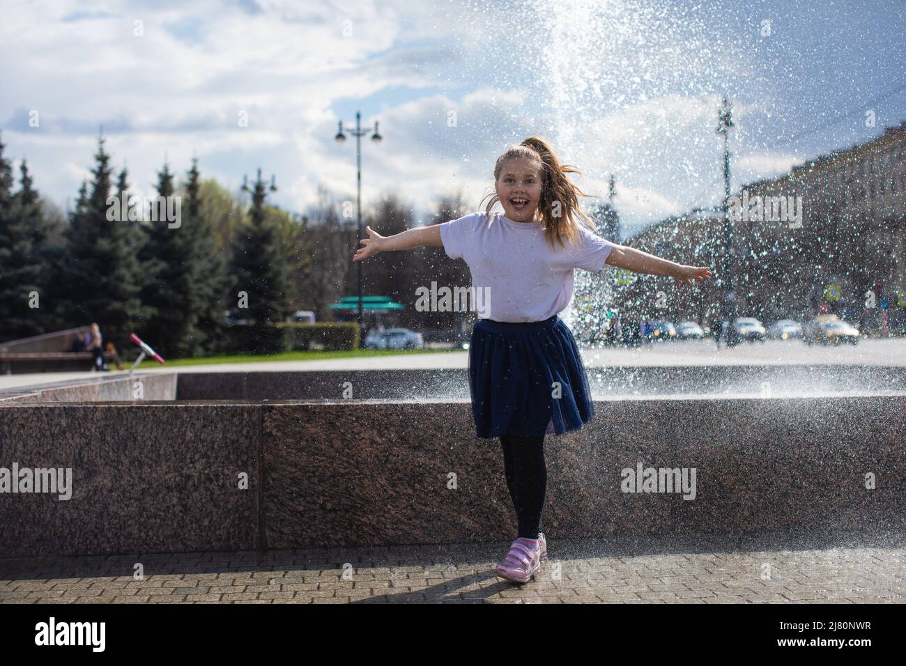 happy little cute girl having fun in splashes a fountain Stock Photo ...