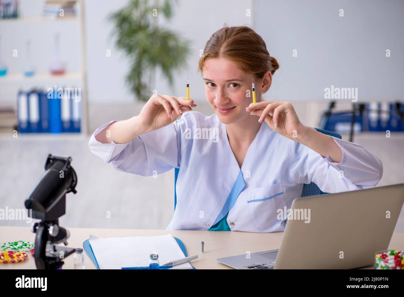 Young girl chemist in drugs synthesis concept Stock Photo - Alamy
