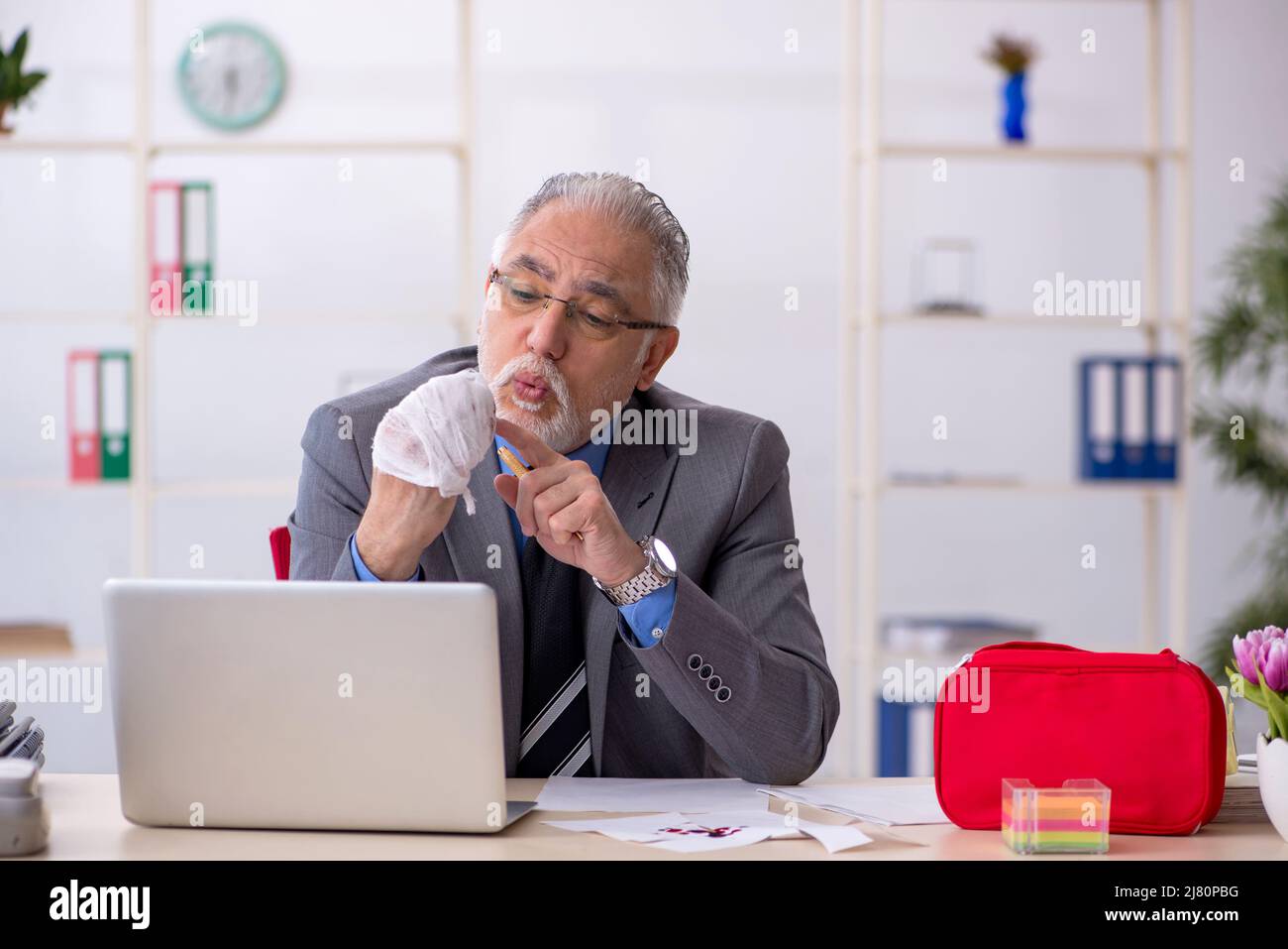 Old businessman employee cutting his hand at workplace Stock Photo - Alamy
