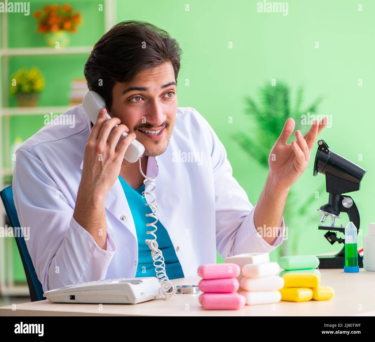 Chemist examining liquid solution speaking hi-res stock photography and ...