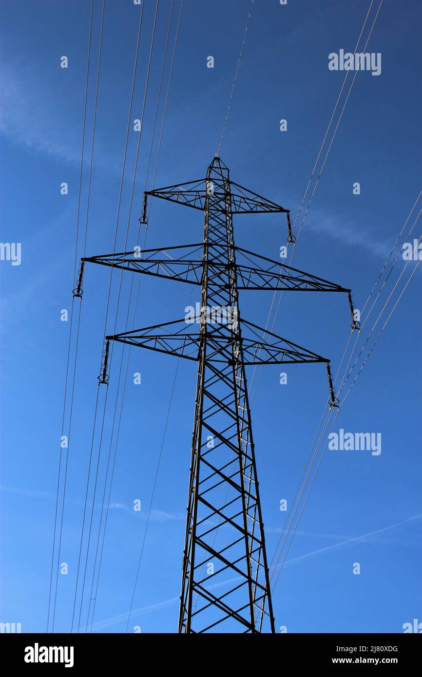 Close up of electricity pylon on a sunny day against a clear blue sky ...