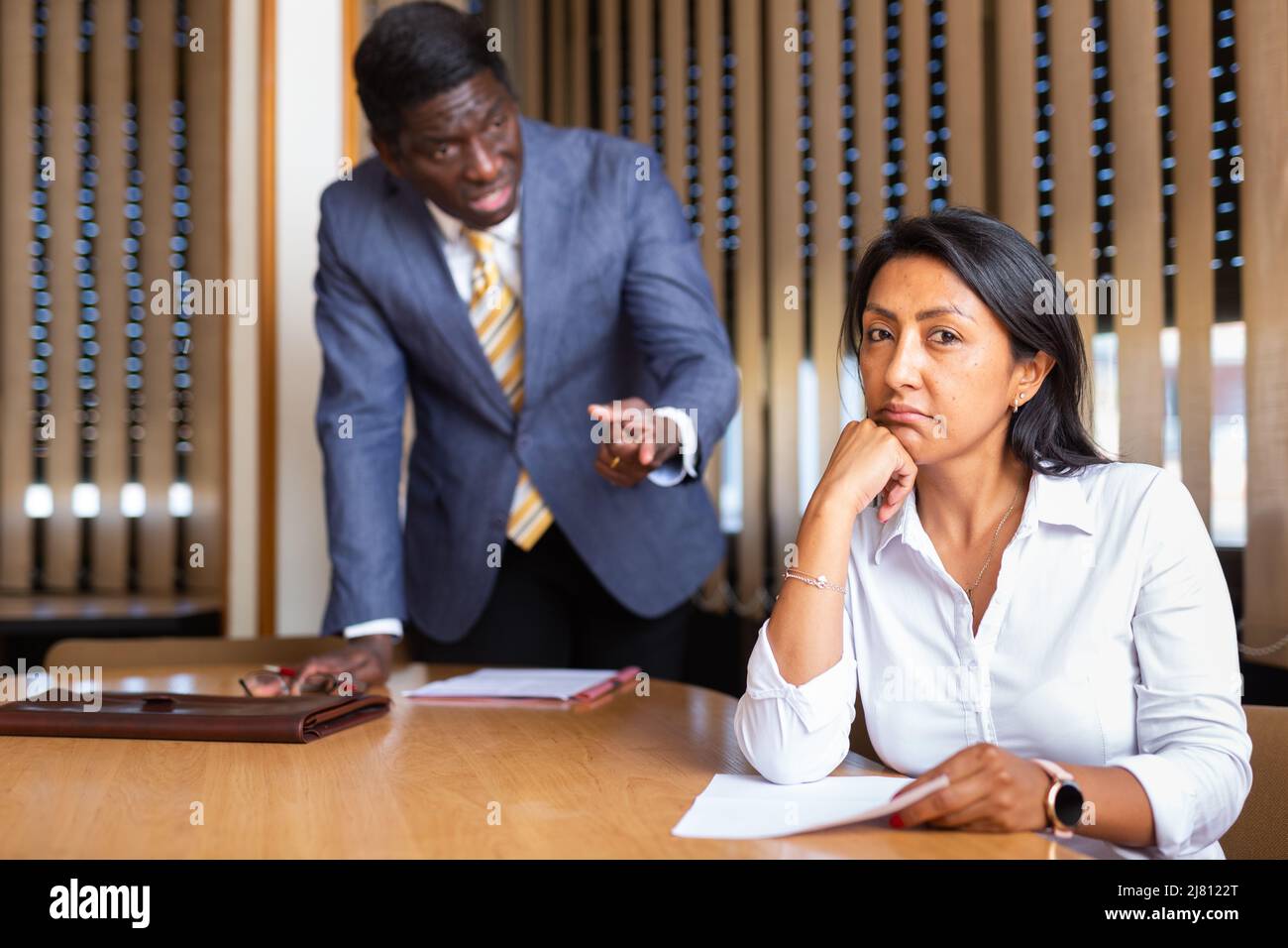 Dissatisfied manager scolding frustrated female assistant Stock Photo ...