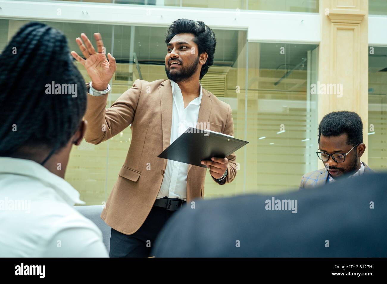 well-dressed business indian men making a report to subordinate ...