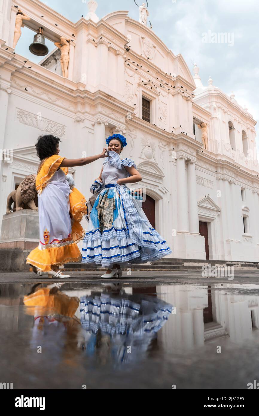Traditional Nicaraguan folklore dancers fixing their dresses in front ...
