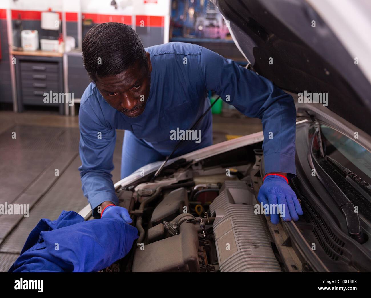 Professional man car mechanician repairing car in auto repair Stock ...