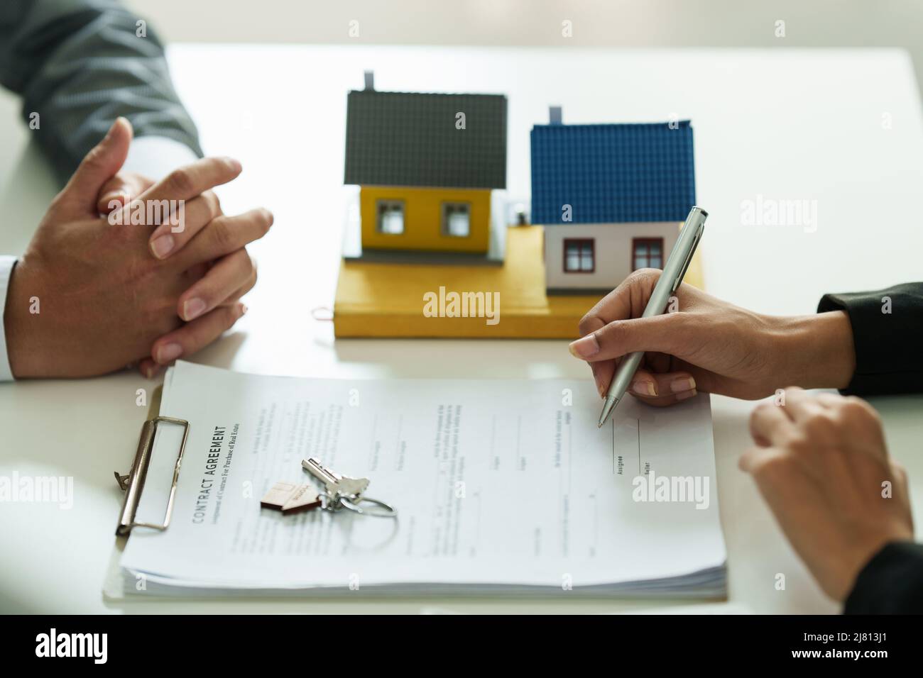 Close up Business woman or Real Estate agent explain signing agreement ...