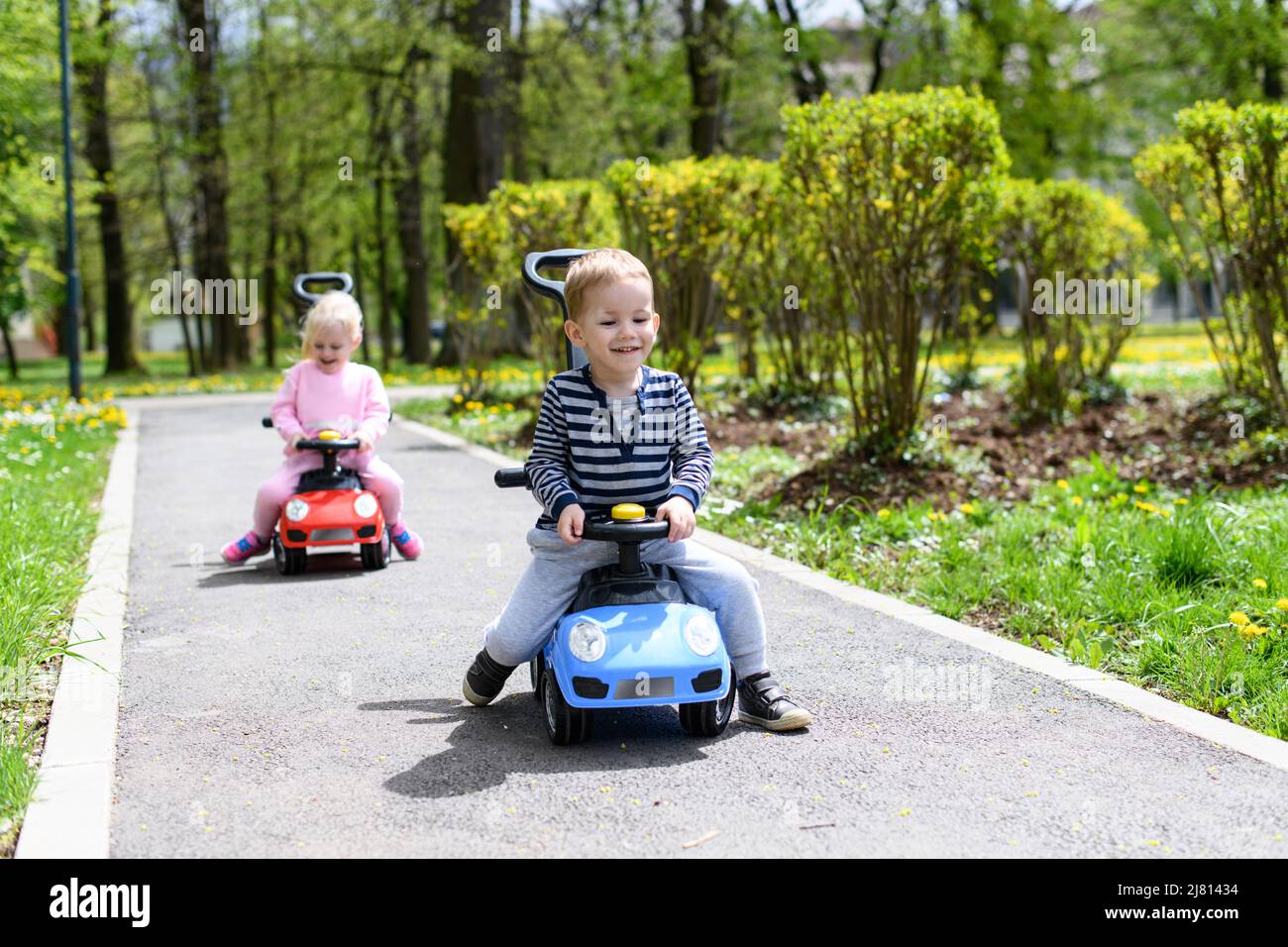 Kids Are Playing With a Toy Car Outdoors in the Park - A Happy Boy and ...
