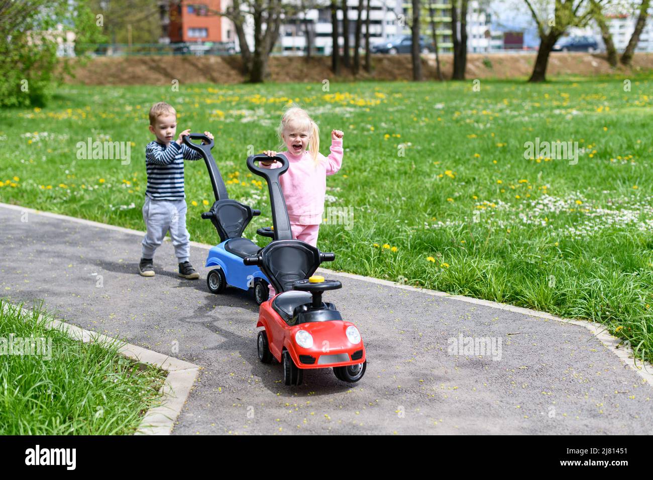 Kids Are Playing With a Toy Car Outdoors in the Park - A Happy Boy and ...