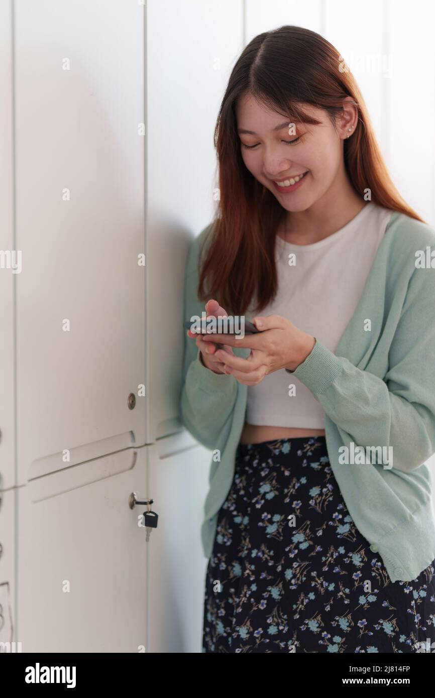 Young college student chatting with her friend at school Stock Photo ...