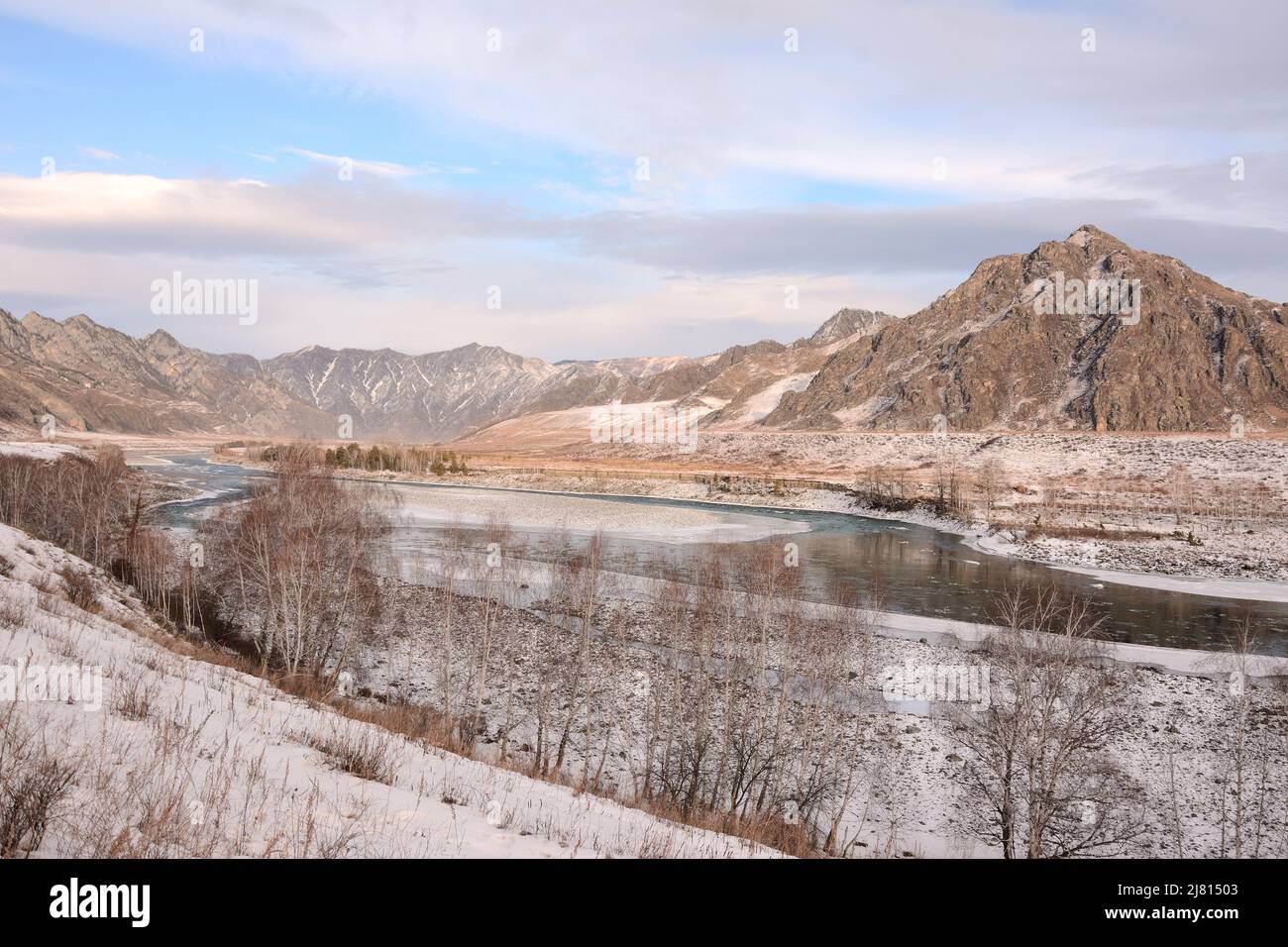 The not completely frozen bed of a beautiful winding river flowing ...