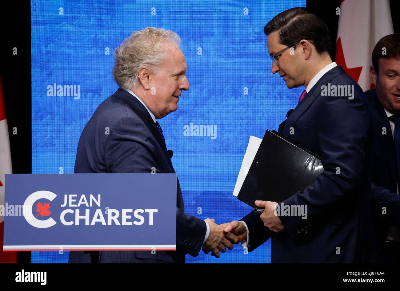 Jean Charest, left, and Pierre Poilievre shake hands following the ...