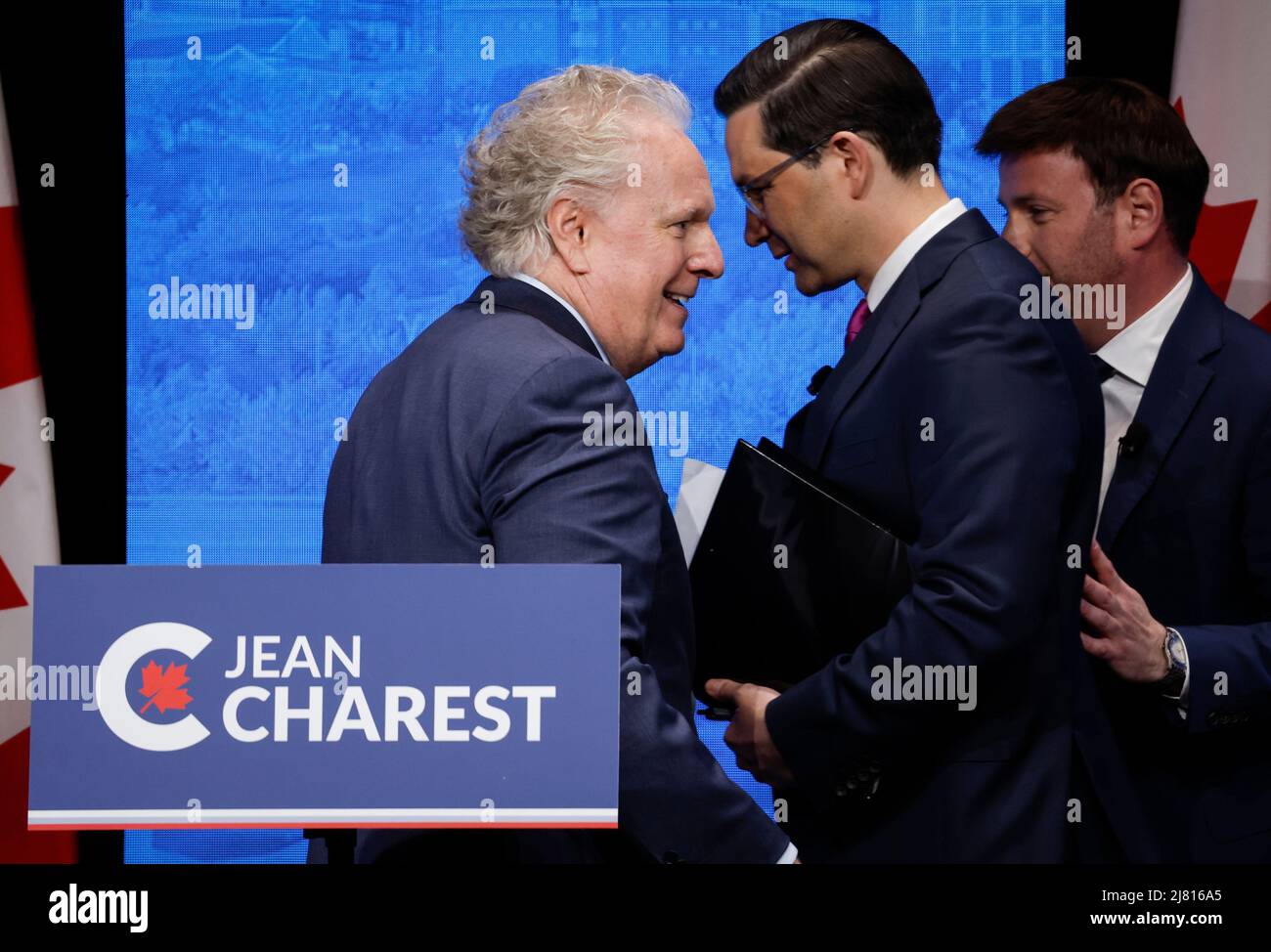 Jean Charest, left, and Pierre Poilievre leave the stage following the ...