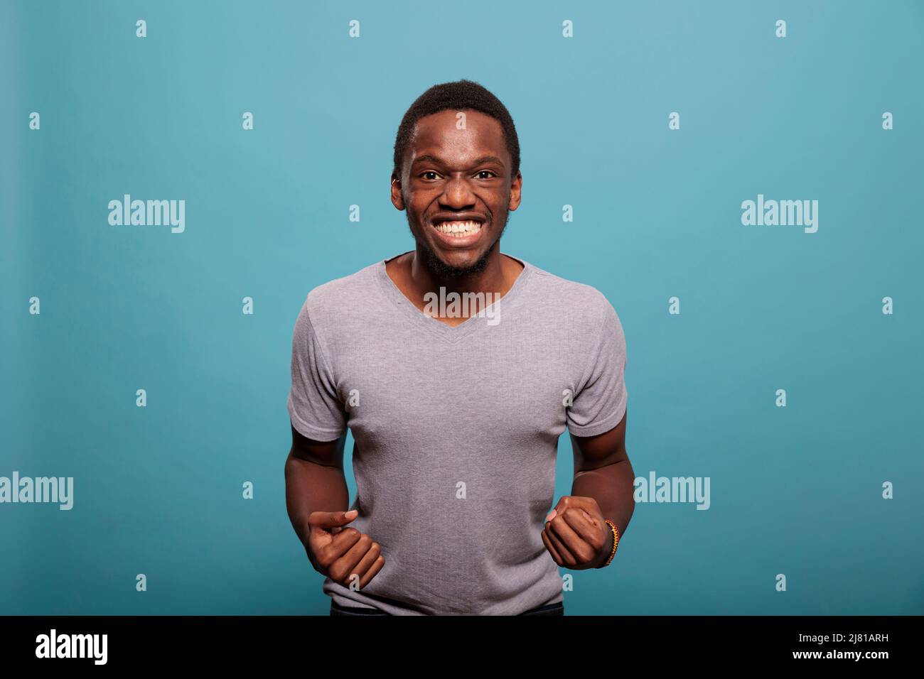 African american man celebrating achievement with clenched fists ...