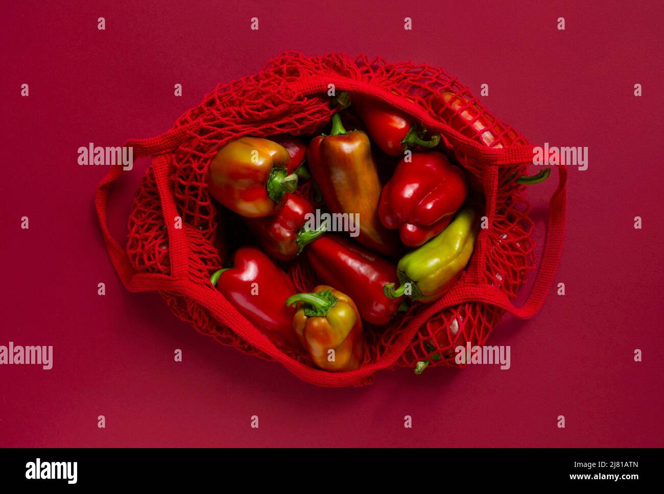 Fresh bell peppers in eco friendly bag on the red background Stock ...