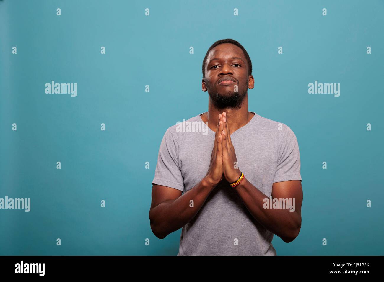 Religious man holding hands in prayer sign to worship God, having faith ...