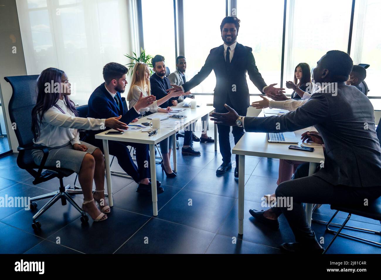 creative team of multiracial men sitting round the desk in formal ...