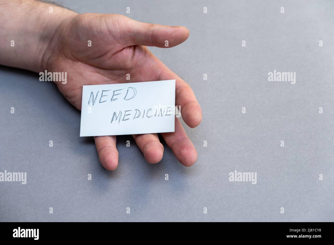 Need medicine. Handwritten gray lettering. Open man's palm with white ...